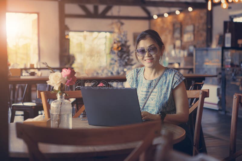 Woman Working on Computer Laptop in Coffee Shop Stock Photo - Image of ...