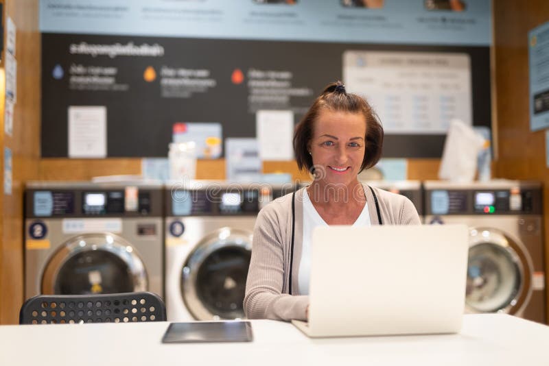 Woman Working on a Computer in Laundry Shop Stock Photo - Image of ...