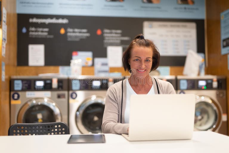 Woman Working on a Computer in Laundry Shop Stock Photo - Image of ...
