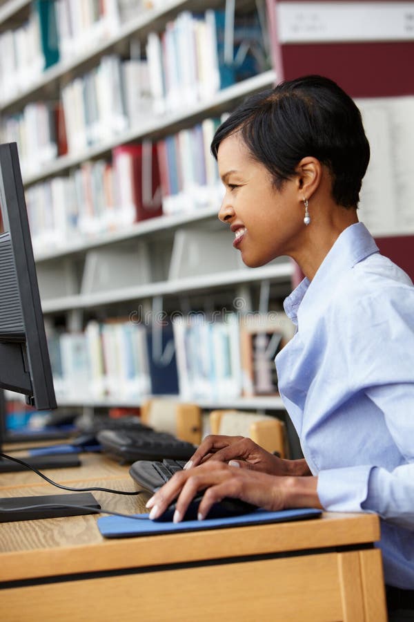 Woman Working on Computer in Library Stock Image - Image of happy ...