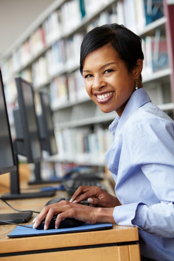 Woman Working on Computer in Library Stock Image - Image of portrait ...