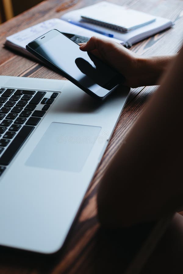 Woman Working on Computer and Looking at the Phone Stock Image - Image ...