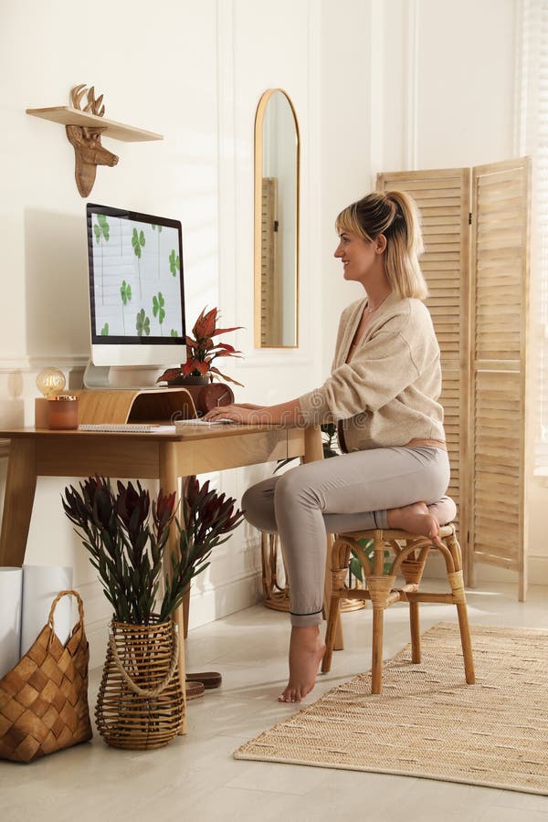 Woman Working on Computer at Table in Room. Interior Design Stock Photo ...