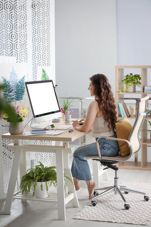 Young Woman Working on Computer at Table in Room Stock Photo - Image of ...