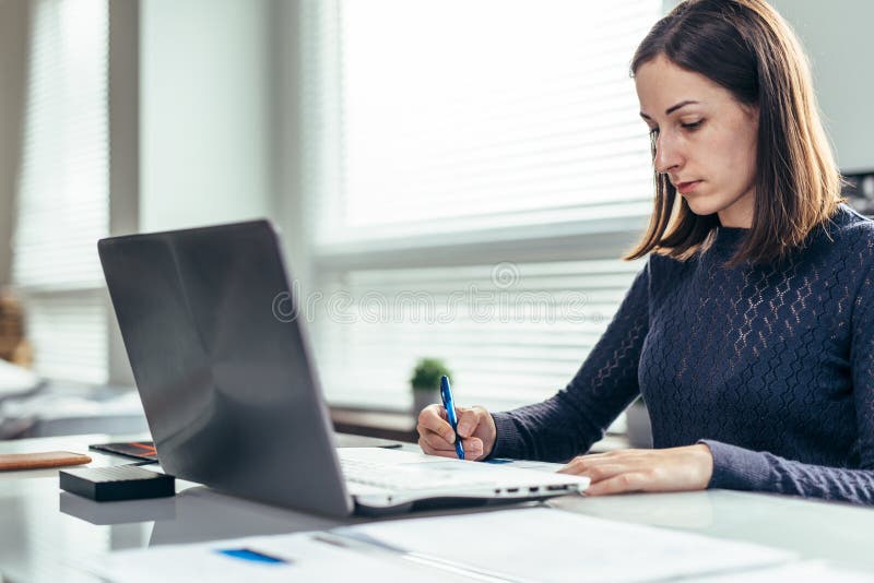 Woman Working at Her Desk, Taking Notes. Stock Image - Image of ...