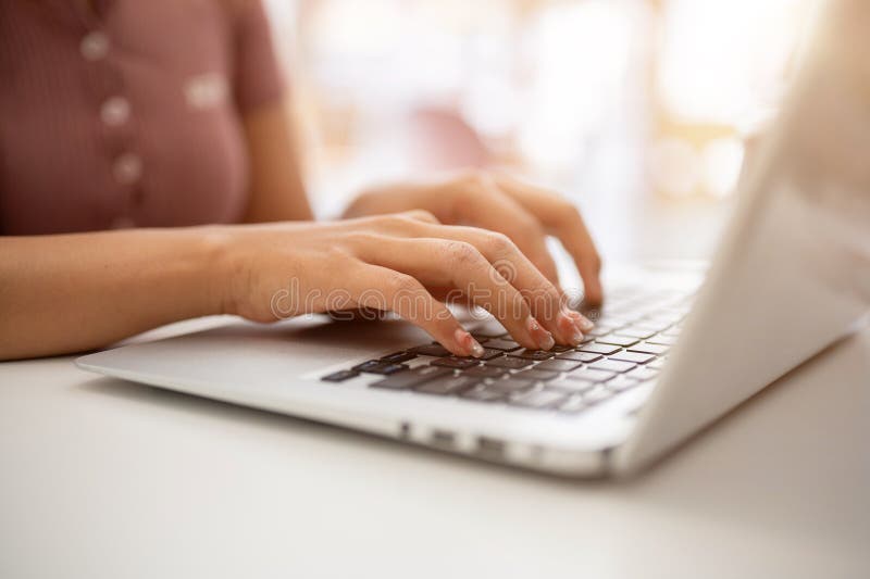 A Woman Working on Her Laptop Computer, Typing on the Laptop Keyboard ...