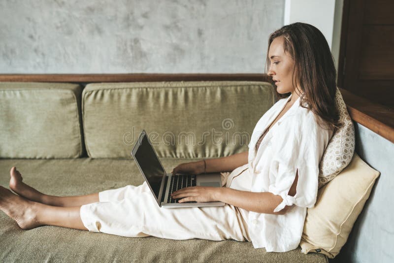 Woman Working from Home at the Computer on the Sofa Stock Photo - Image ...