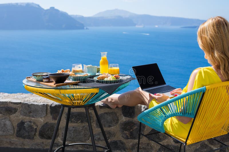 Woman Working with Laptop Computer while Eating Breakfast Stock Photo ...