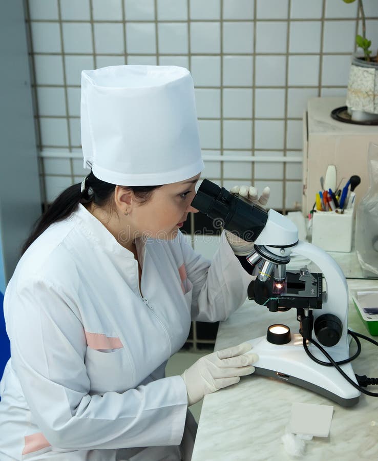 Doctor Looking Under a Microscope Stock Photo - Image of staring, stare ...