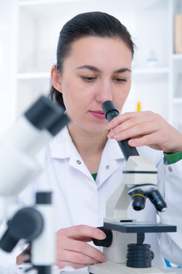 Woman Working with a Microscope in a Lab.Toning Image Stock Photo ...