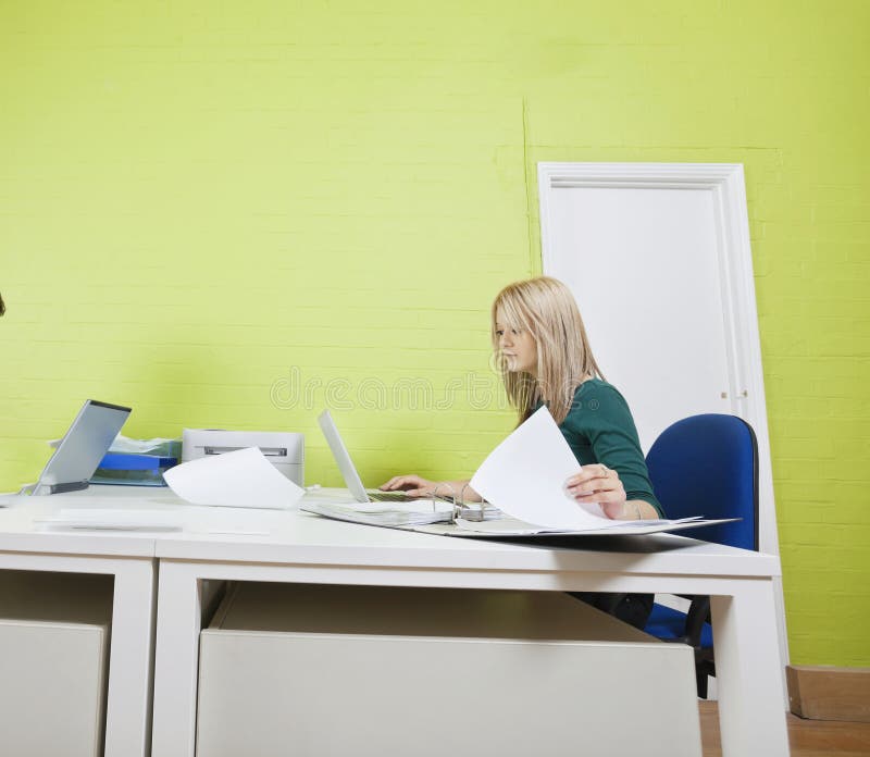 Woman Working in Office Against Green Wall Stock Image - Image of ...