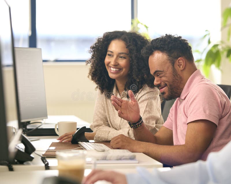 Woman Working in Office Based Business Training Man with Down Syndrome ...