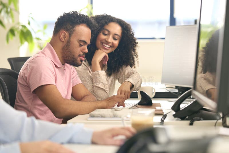 Woman Working in Office Based Business Training Man with Down Syndrome ...