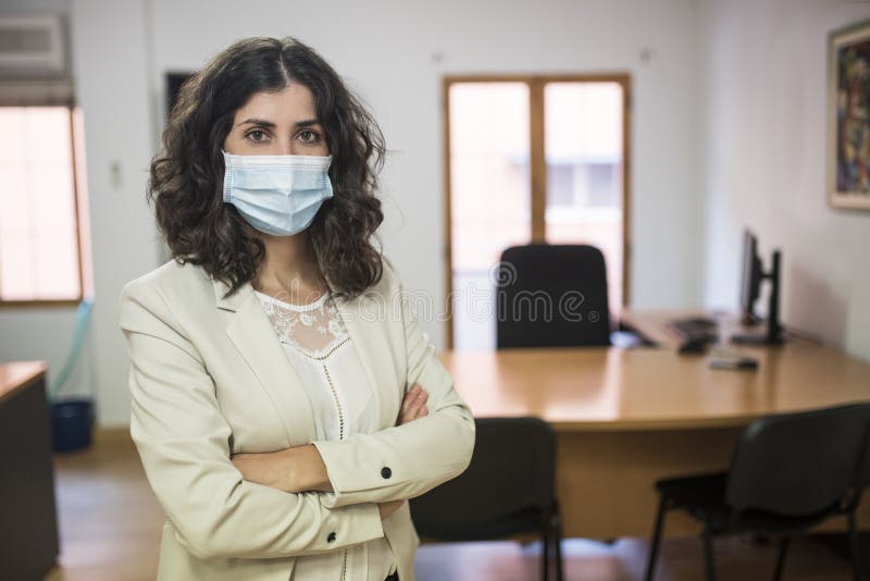 Woman Working in Office with Face Mask Posing and Looking at Camera ...