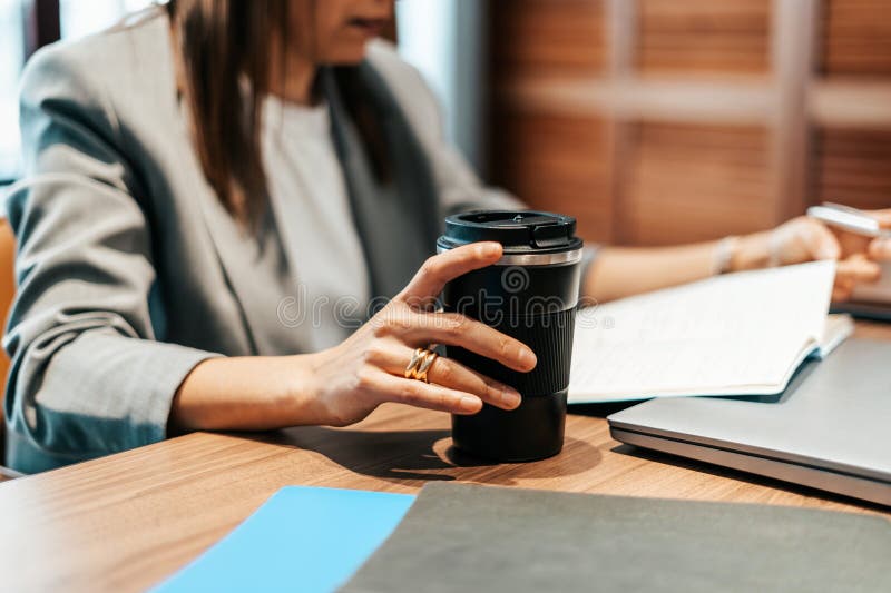 Woman Working in an Office with a Thermos Flask of Coffee Stock Photo ...