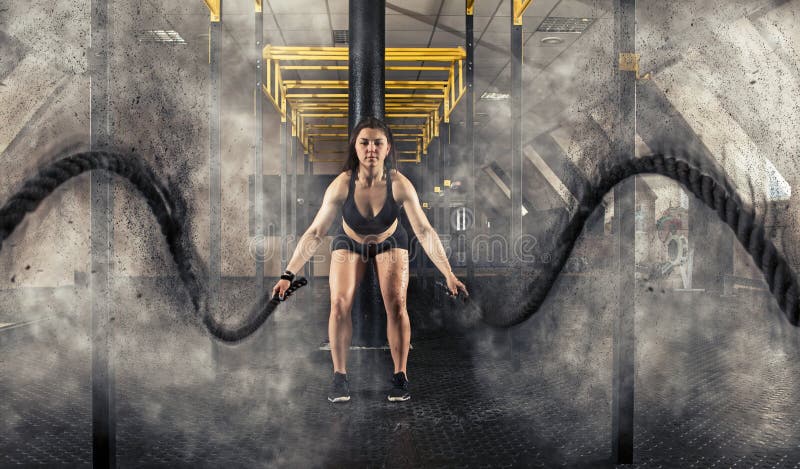 Woman Working Out with Battle Ropes Stock Photo - Image of effort ...