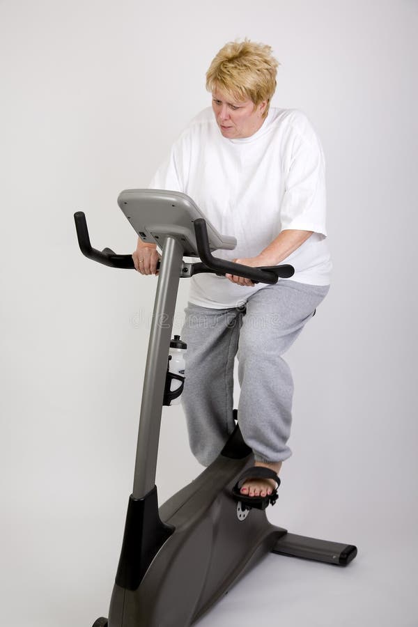 Woman working out on bike stock image. Image of lifestyle - 2698717
