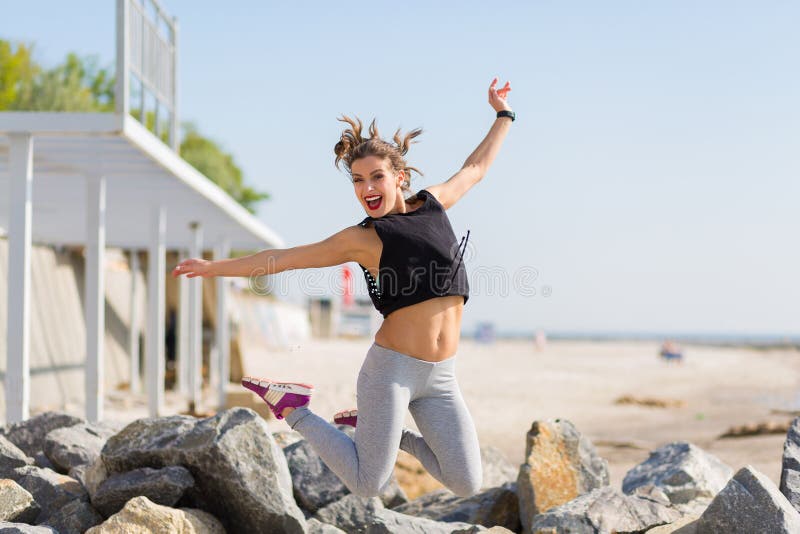 Woman Working Out and Jumping at the Summer Beach Stock Image - Image ...