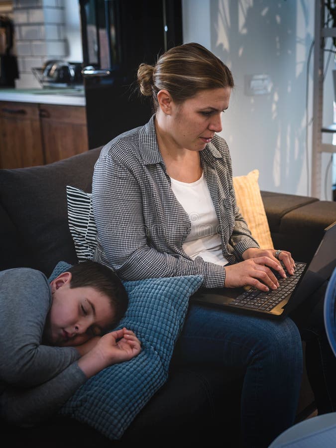 Mother Working Using Laptop Computer at Home while Son is Sleeping ...