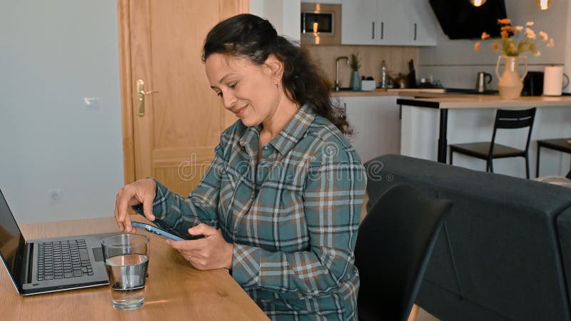 Woman Working Remotely in a Modern Home Office Setting with Technology ...