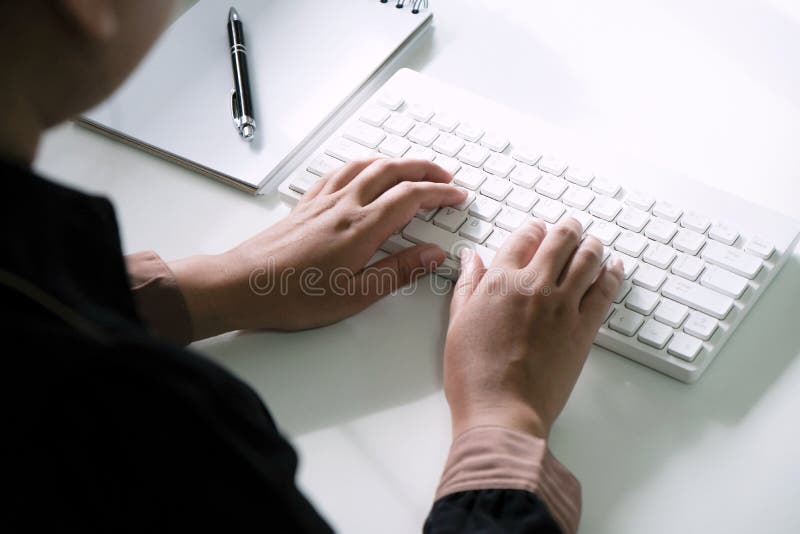 Woman Working by Using a Laptop Computer on Wooden Table. Hands Typing ...