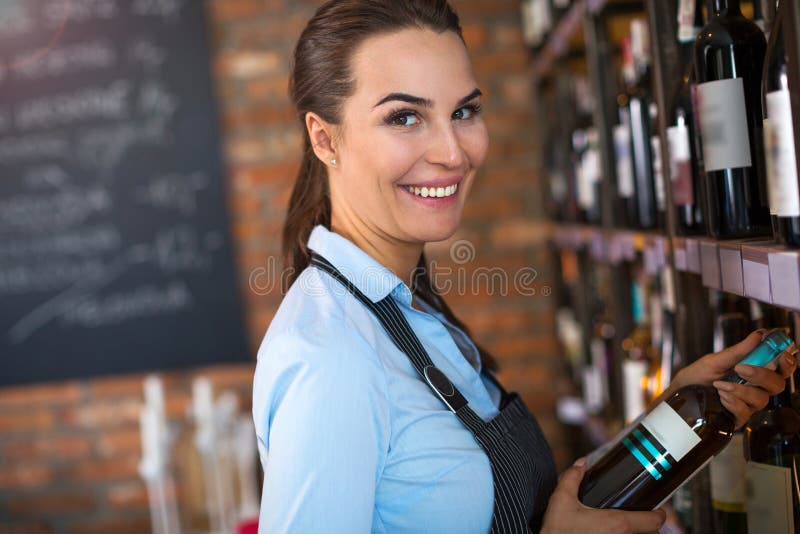 Woman working in wine shop stock photo. Image of occupation - 95298520