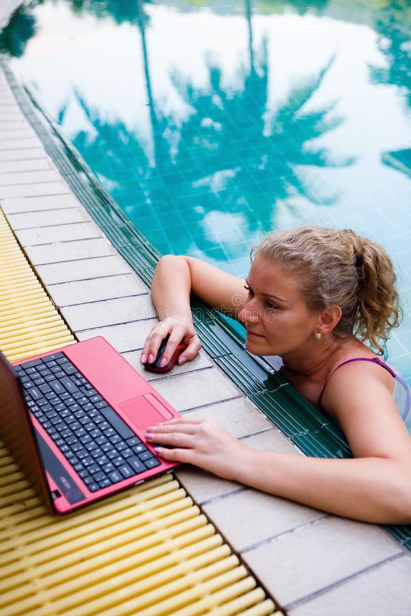A Woman Works on the Computer in the Pool. Stock Image - Image of game ...