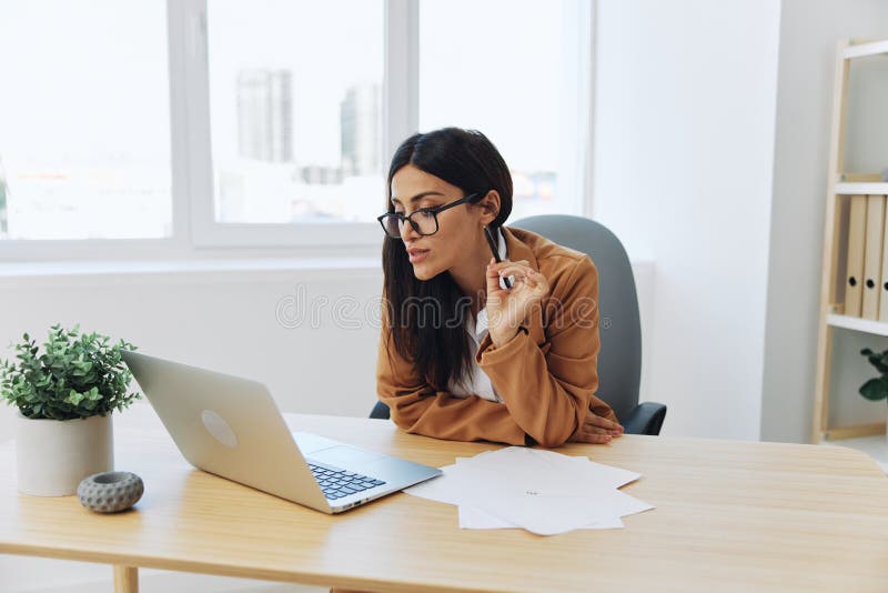 A Woman Works and Learns by Writing Down Text on Paper with a Pen and ...