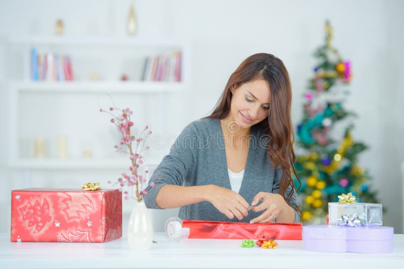 Woman wrapping the gifts stock photo. Image of decoration - 127768470
