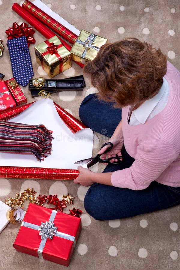 An Elf Wrapping Christmas Presents in the North Pole Stock Image ...