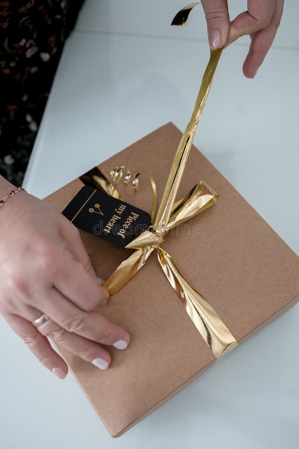 A Woman Wraps a Gift . the Process of Packaging an Environmentally Friendly Gift.Focus on the ...