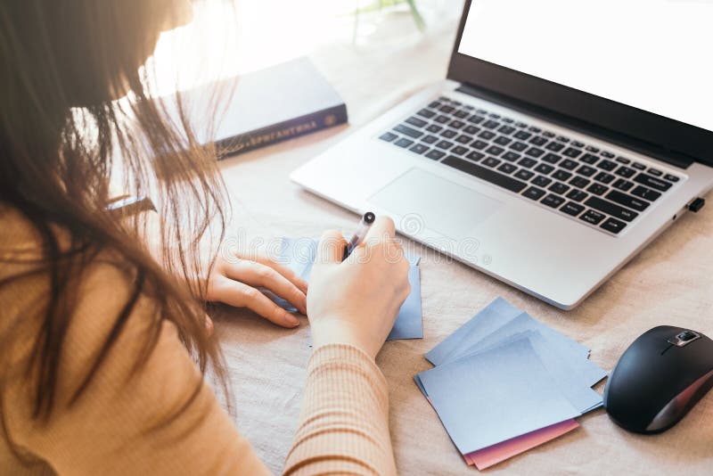Woman Writes Notes on Stickers. Work Place with Laptop and Space for ...