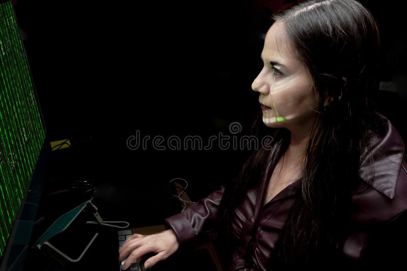 Woman Writes Programming Languages In Development Code In Front Of Computer Seated At Work Desk