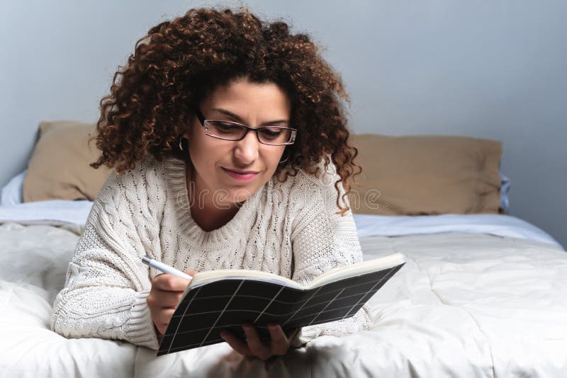 Woman Writing on Bed at Home Stock Photo - Image of domicile, home ...