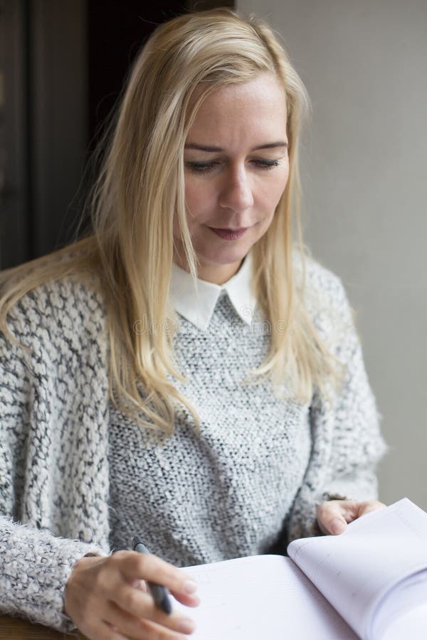 Woman writing in a book stock image. Image of notebook - 48798499