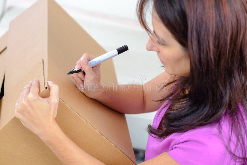 Woman Writing on Cardboard Box Stock Image - Image of warehouse, table ...