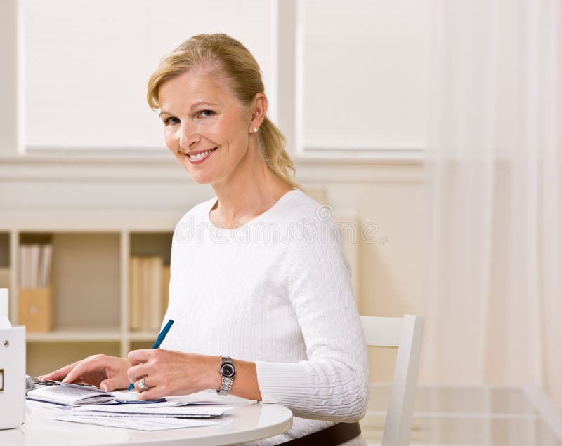 Woman writing checks stock photo. Image of check, adult - 17049598