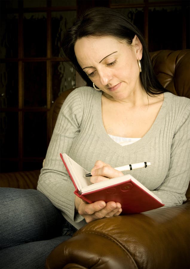 Woman writing in diary stock image. Image of indoor, armchair - 23670891