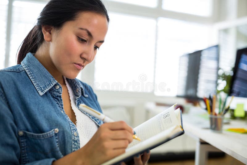 Woman writing in diary stock photo. Image of noting, people - 84084936