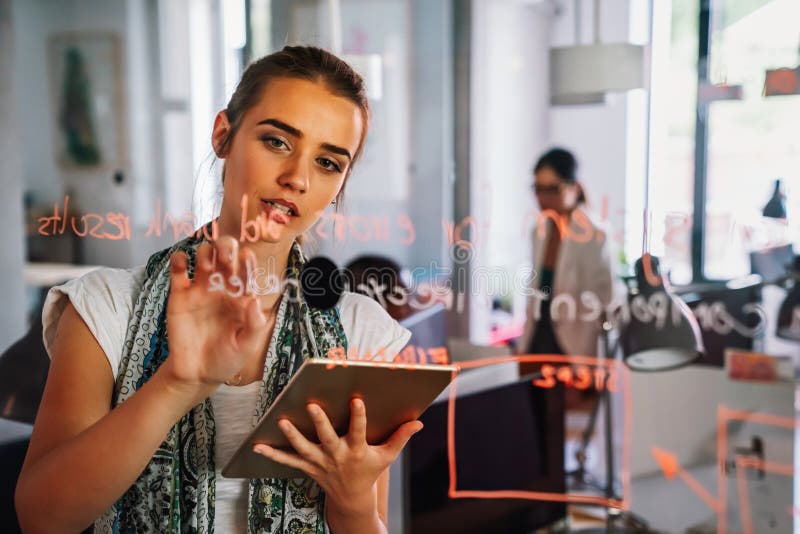 Female Coach Making Notes of Information during Workflow Planning ...