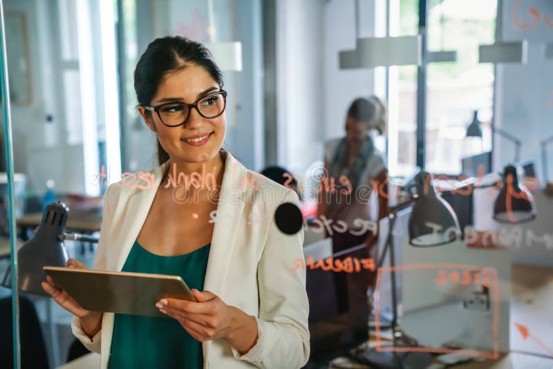 Female Coach Making Notes of Information during Workflow Planning ...