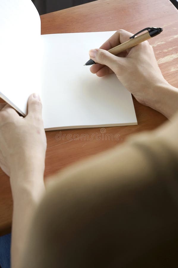 Woman writing on notebook stock image. Image of desk - 27452789