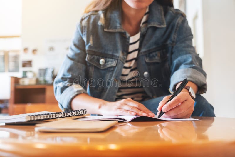 A Woman Writing on a Notebook on the Table Stock Photo - Image of ...