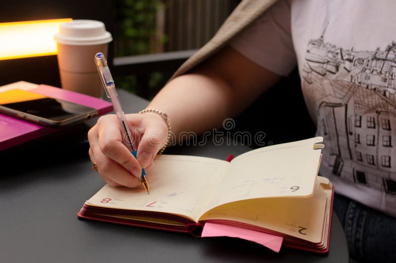 Woman Writing in Notebook at the Table Stock Photo - Image of study ...