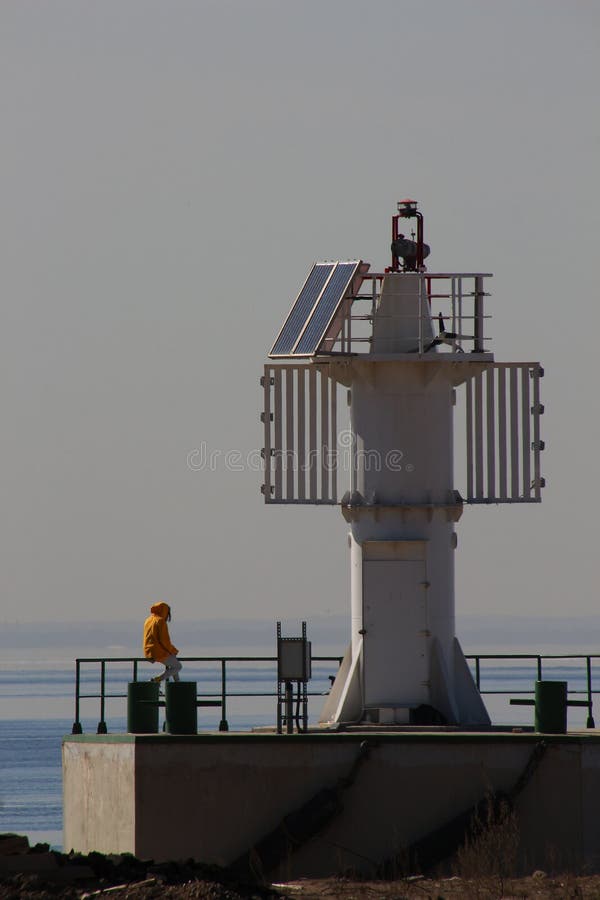 Woman in a Yellow Jacket at the Lighthouse Stock Photo - Image of ...