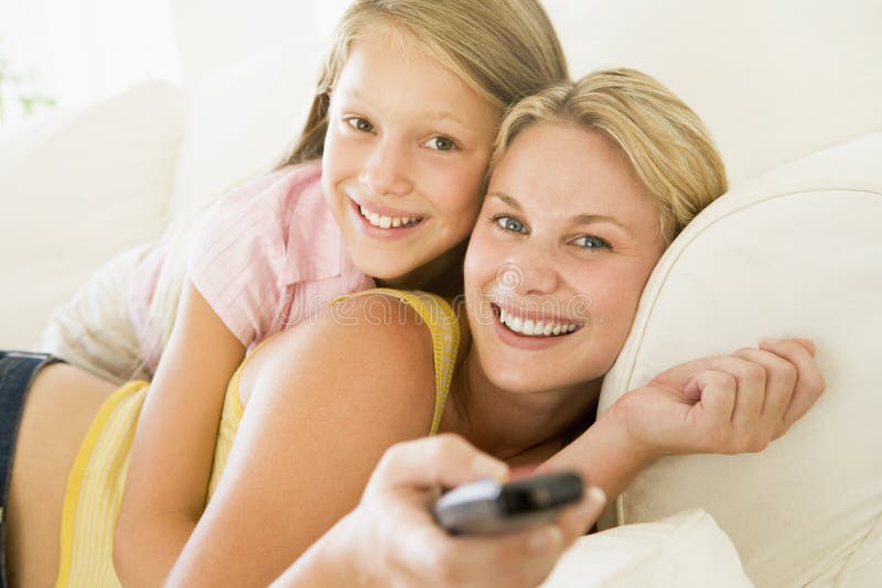 Family Sitting in Living Room with Remote Control Stock Photo - Image ...