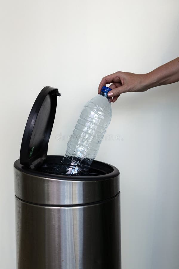 A Woman S Hand Throwing Out a Plastic Bottle in a Rubbish Bin Stock ...