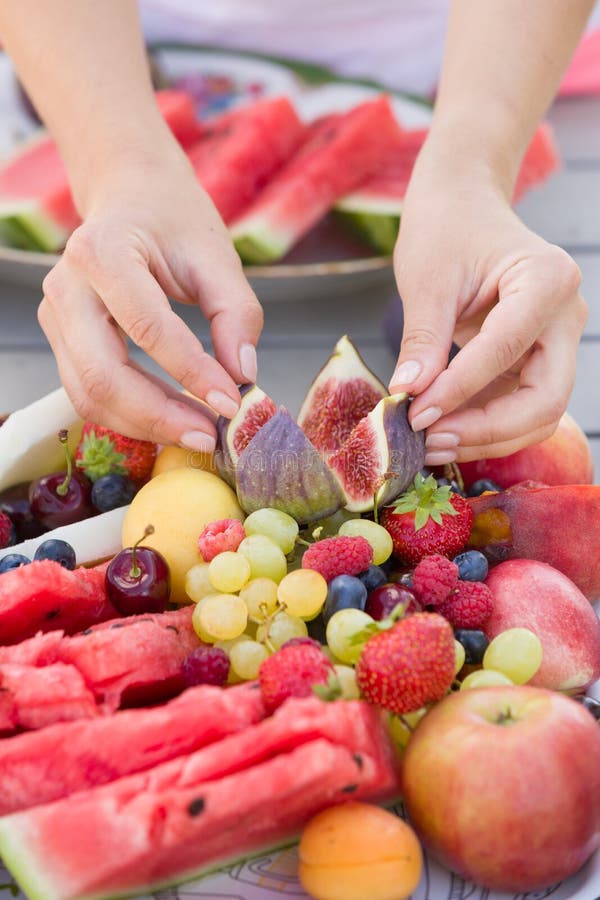 Womans Hands Putting Summer Organic Fruit On The Plate Melon Peach