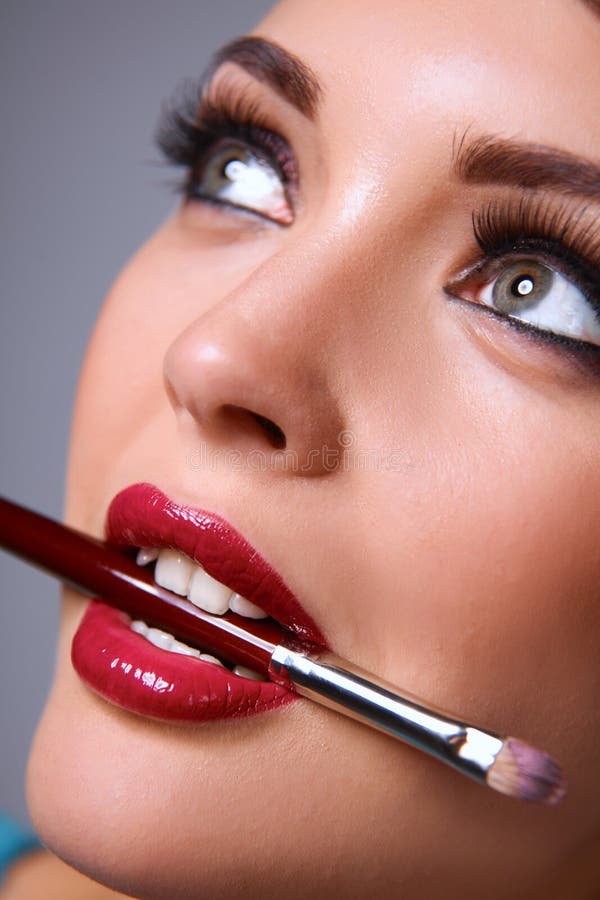 Womans Lips Holding Make Up Brush Stock Image - Image of model, female ...