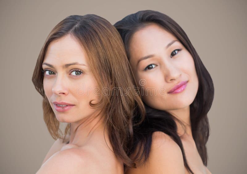 Women Back To Back Against Brown Background Stock Photo - Image of ...
